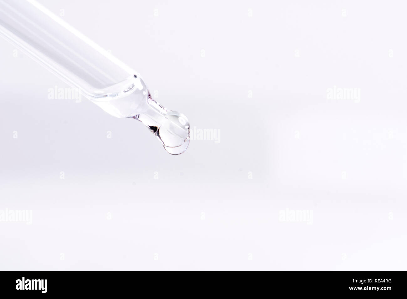 Dropping a liquid from a pipette Stock Photo - Alamy