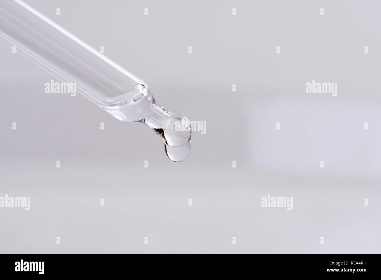 Dropping a liquid from a pipette Stock Photo - Alamy