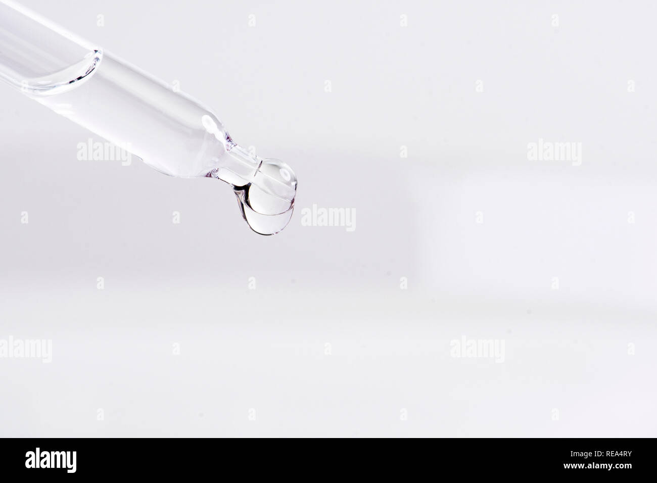 Dropping a liquid from a pipette Stock Photo - Alamy