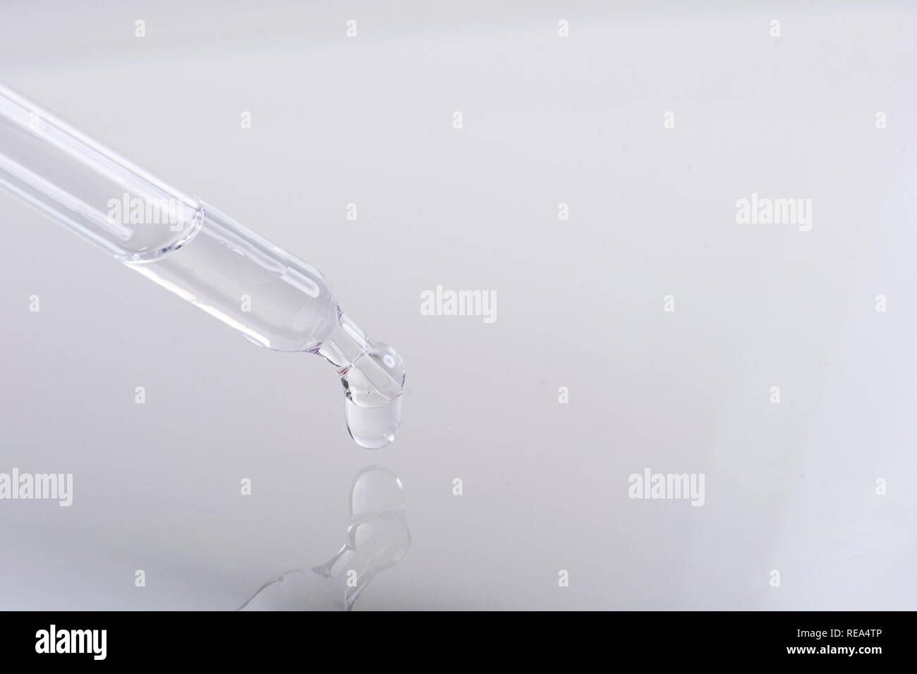 Pipette with water on white background Stock Photo - Alamy