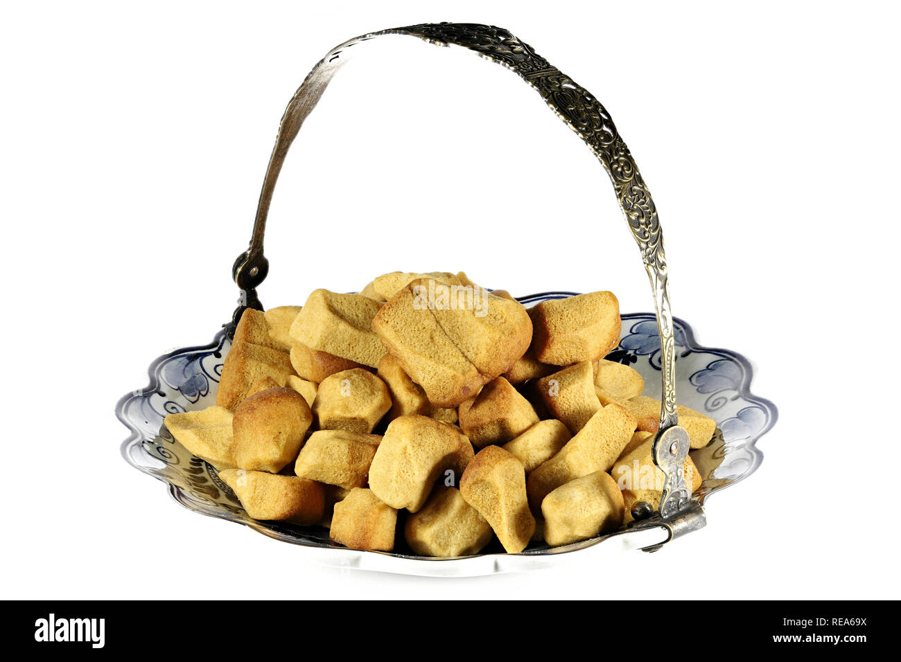 Dutch pepernoten (peppernuts) on a Delftware plate isolated on white ...