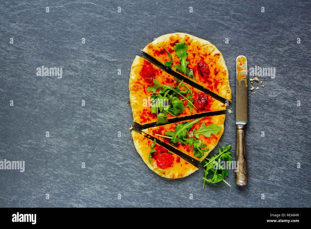 Freshly baked vegetarian pizza with arugula flat lay Stock Photo - Alamy
