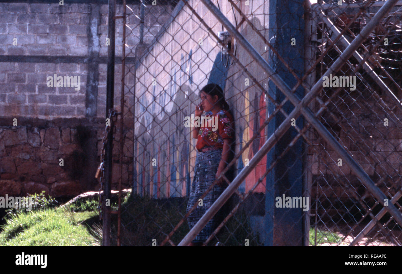 An indigenous Kiche Mayan woman uses her mobile (cell) phone ...