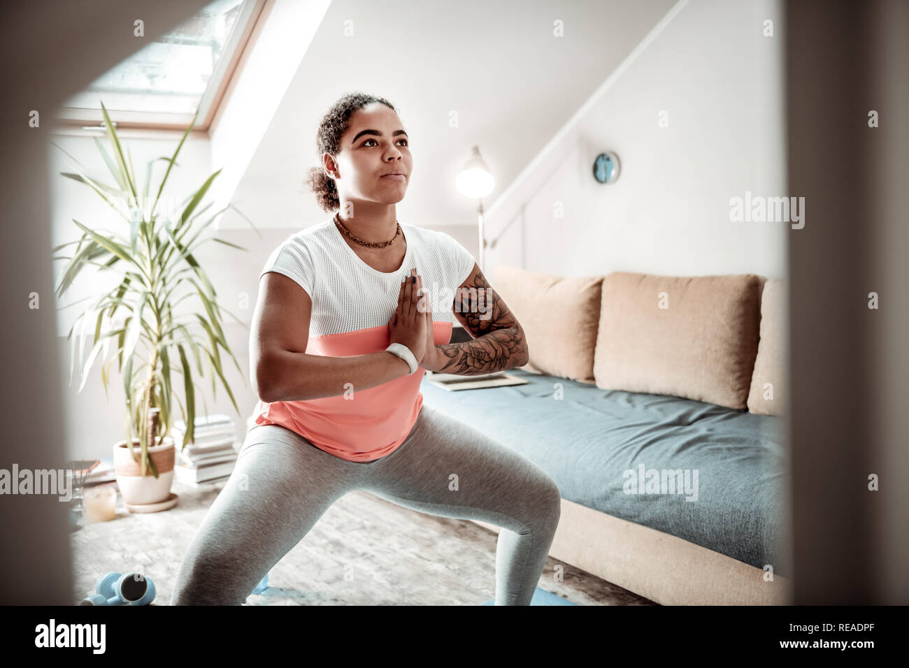 Dark-haired concentrated woman staying in prayerful posture Stock Photo ...