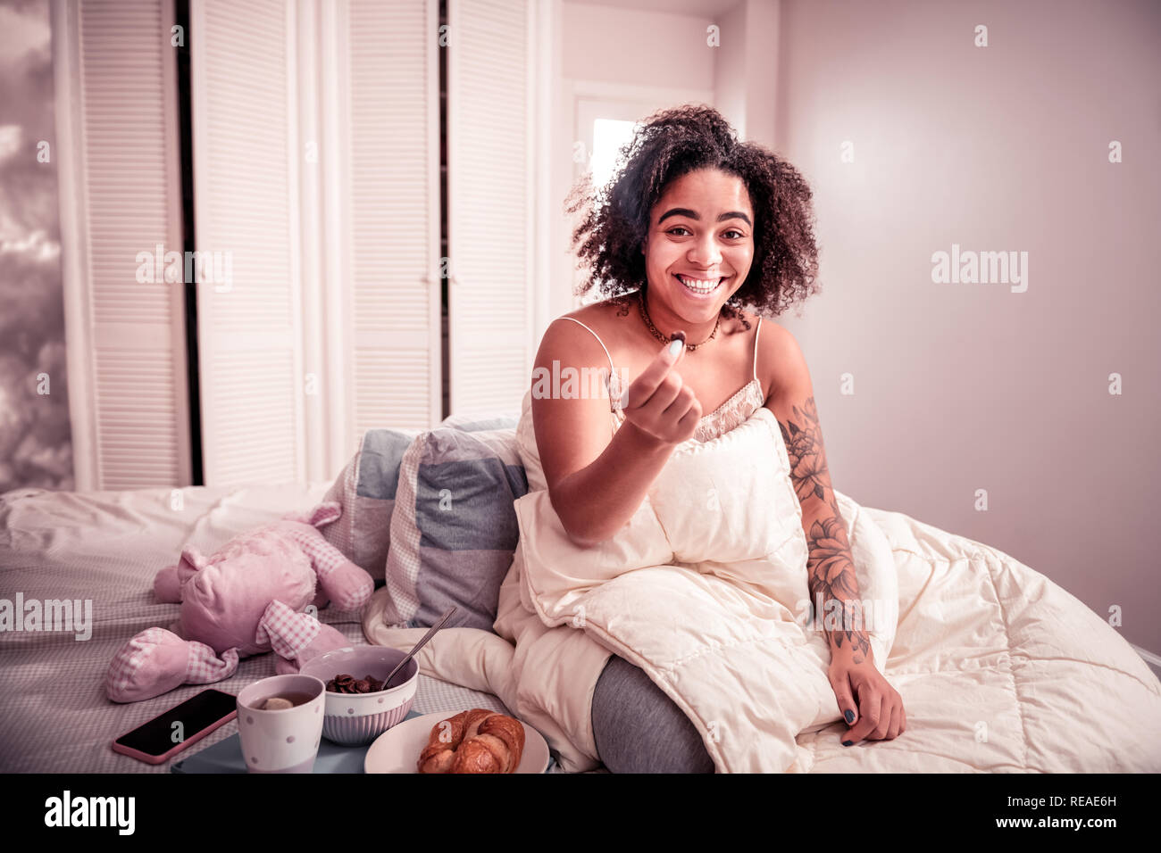 Smiling cheerful lady with curly hair carrying chocolate cereal Stock ...