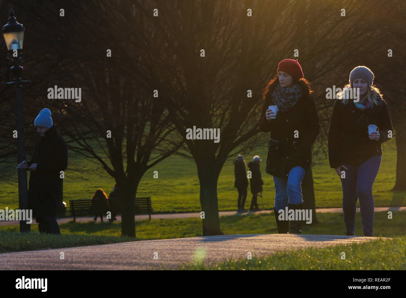 People are seen at the Primrose Hill during a golden winter sunset ...