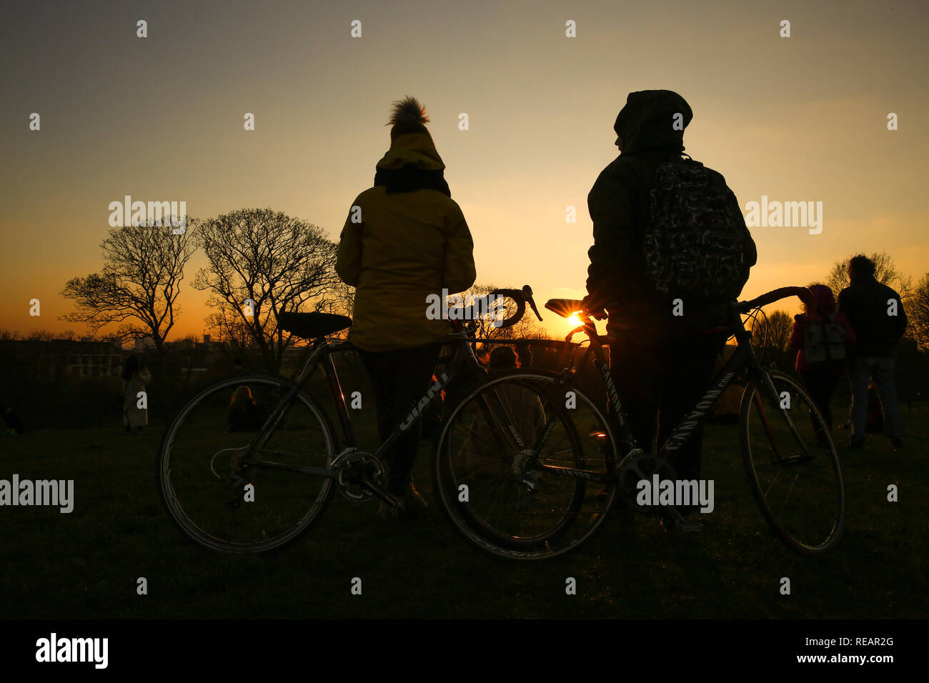 A couple with bicycles are seen at the Primrose Hill during a golden ...