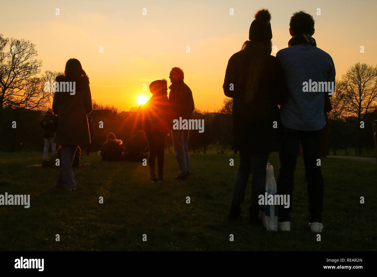 People are seen at the Primrose Hill during a golden winter sunset ...