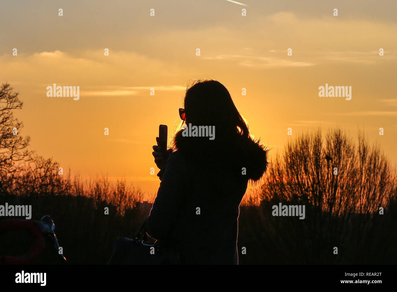 A woman is seen taking pictures at the Primrose Hill taking photograph ...