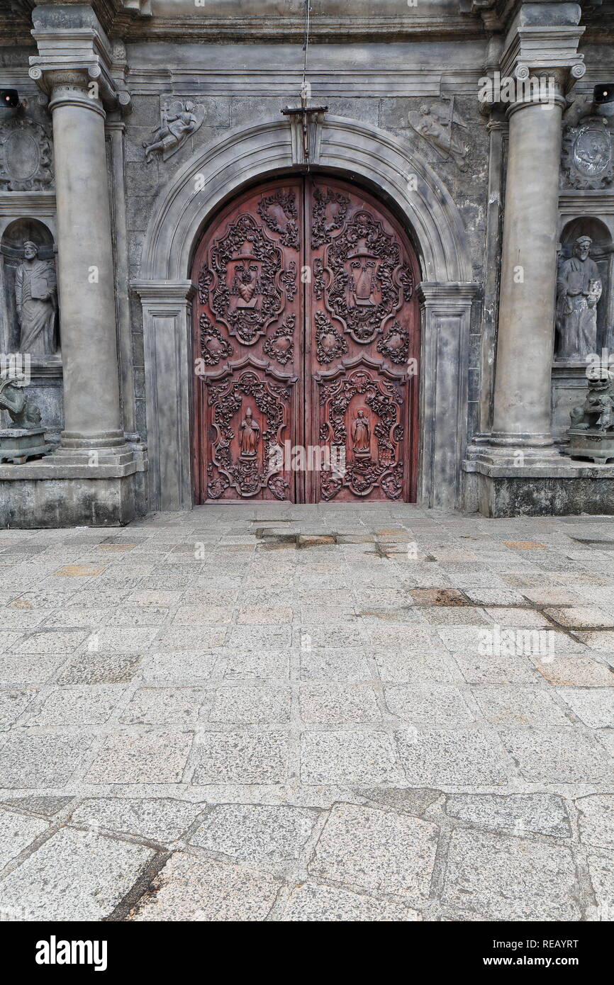 Adobe stone facade-intricately carved wooden set of stately doors-main ...
