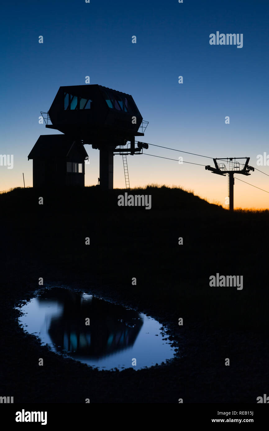 A ski lift and building under a summer starry sky at Mt Buller in the ...