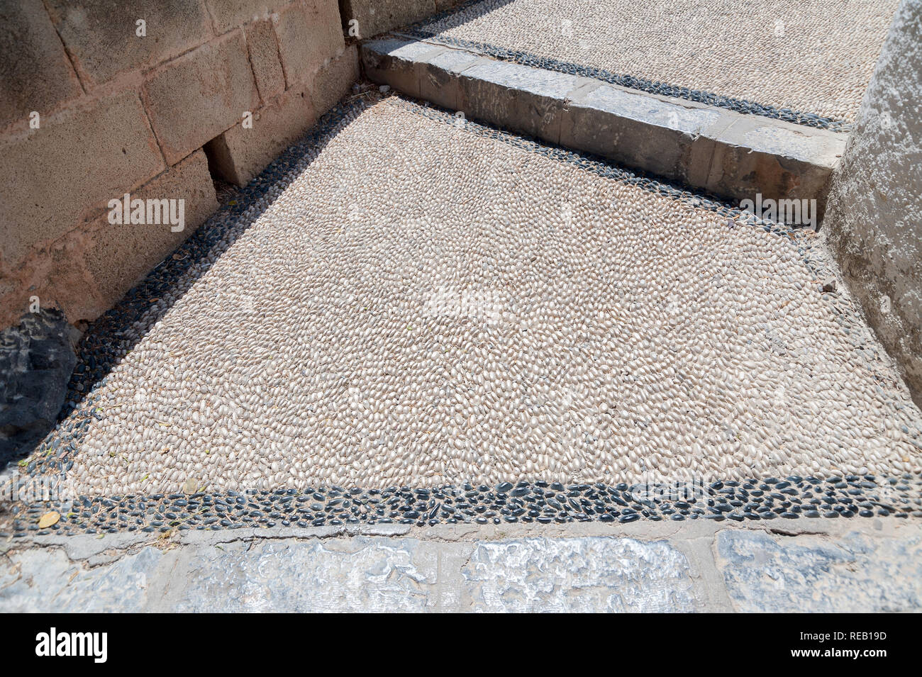 Pebble stone mosaic. Rosetta floral motif. Pavement. Lindos Town. Greek ...