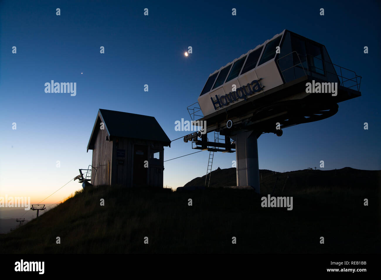 A ski lift and building under a summer starry sky at Mt Buller in the ...