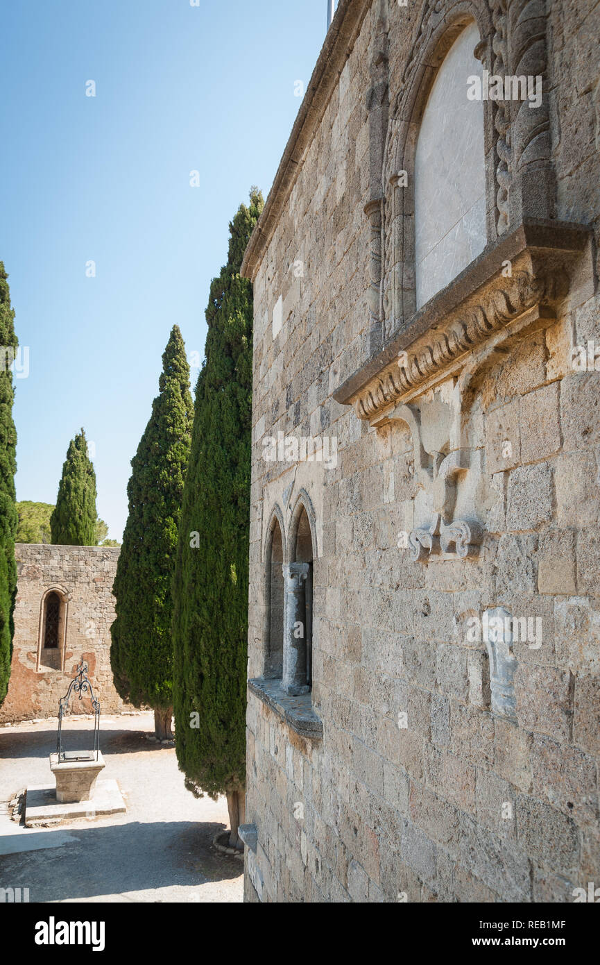 Monastery of Filerimos, Greece. 05/28/2018. Old well in yard surrounded ...