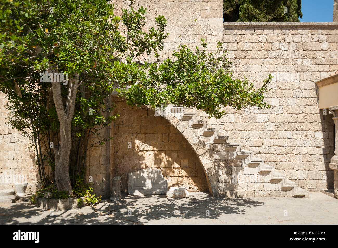 Stone volute, top part of Ionic column. Stone stairs build on arch ...