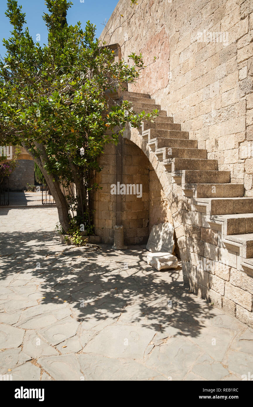 Stone volute, top part of Ionic column. Stone stairs build on arch ...