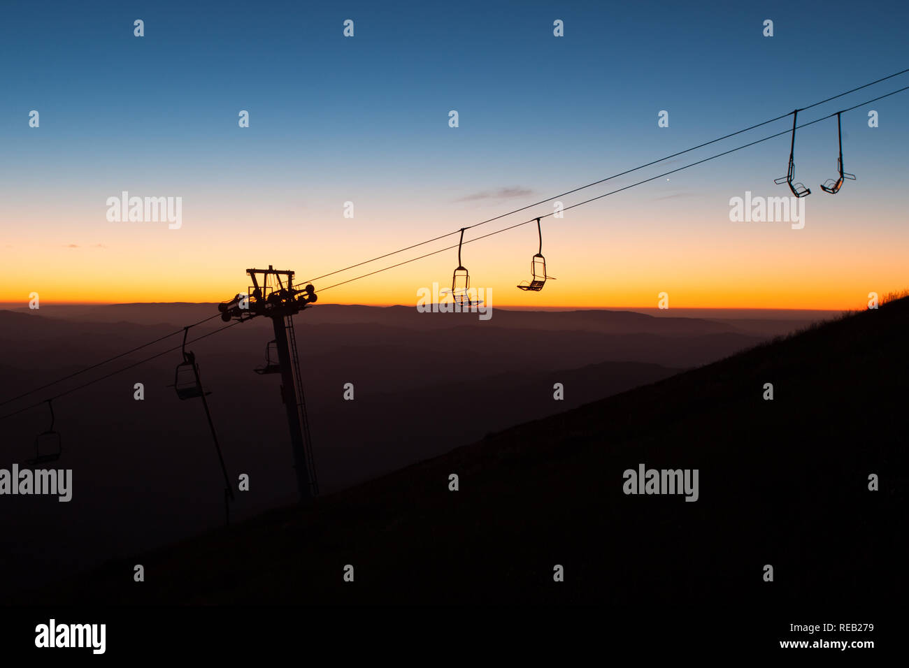 A ski lift and building under a summer starry sky at Mt Buller in the ...