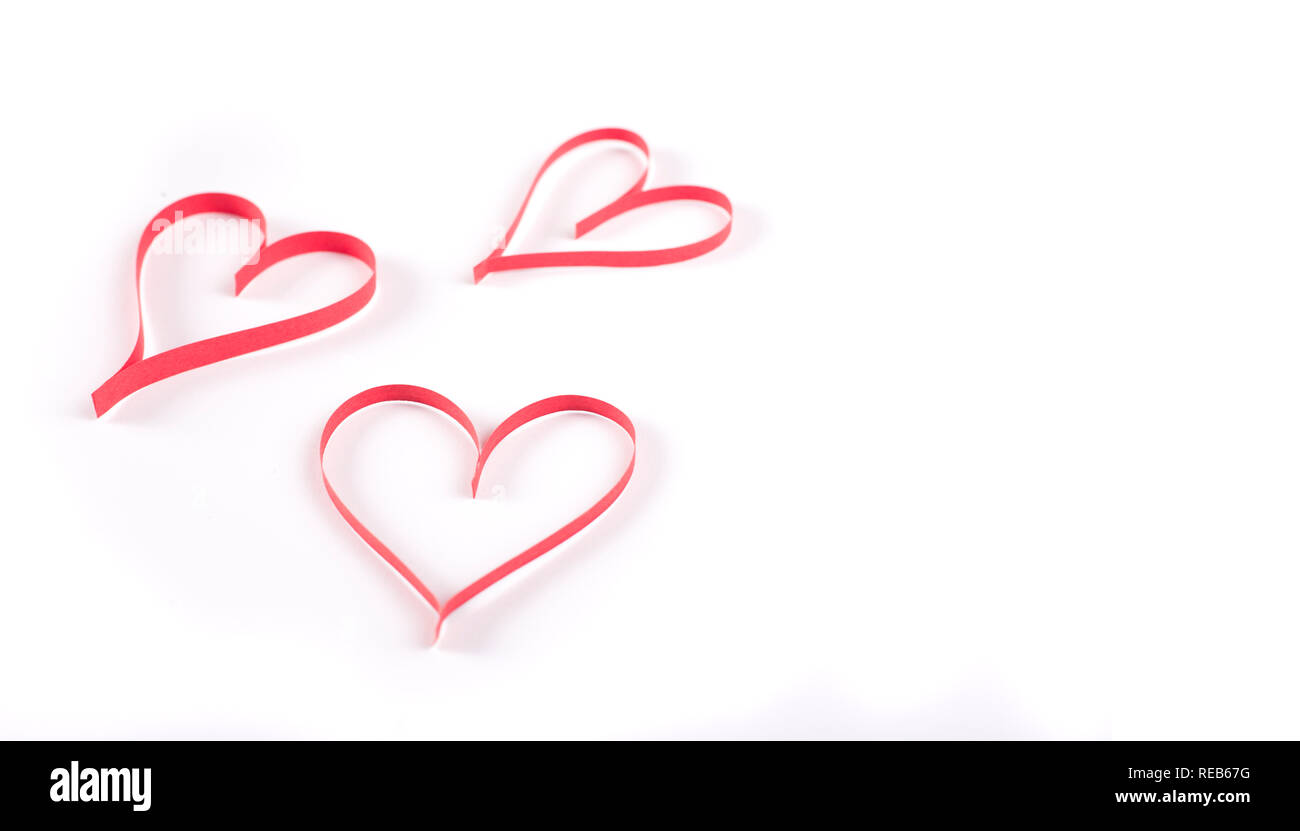 three red heart shape on white background Stock Photo - Alamy