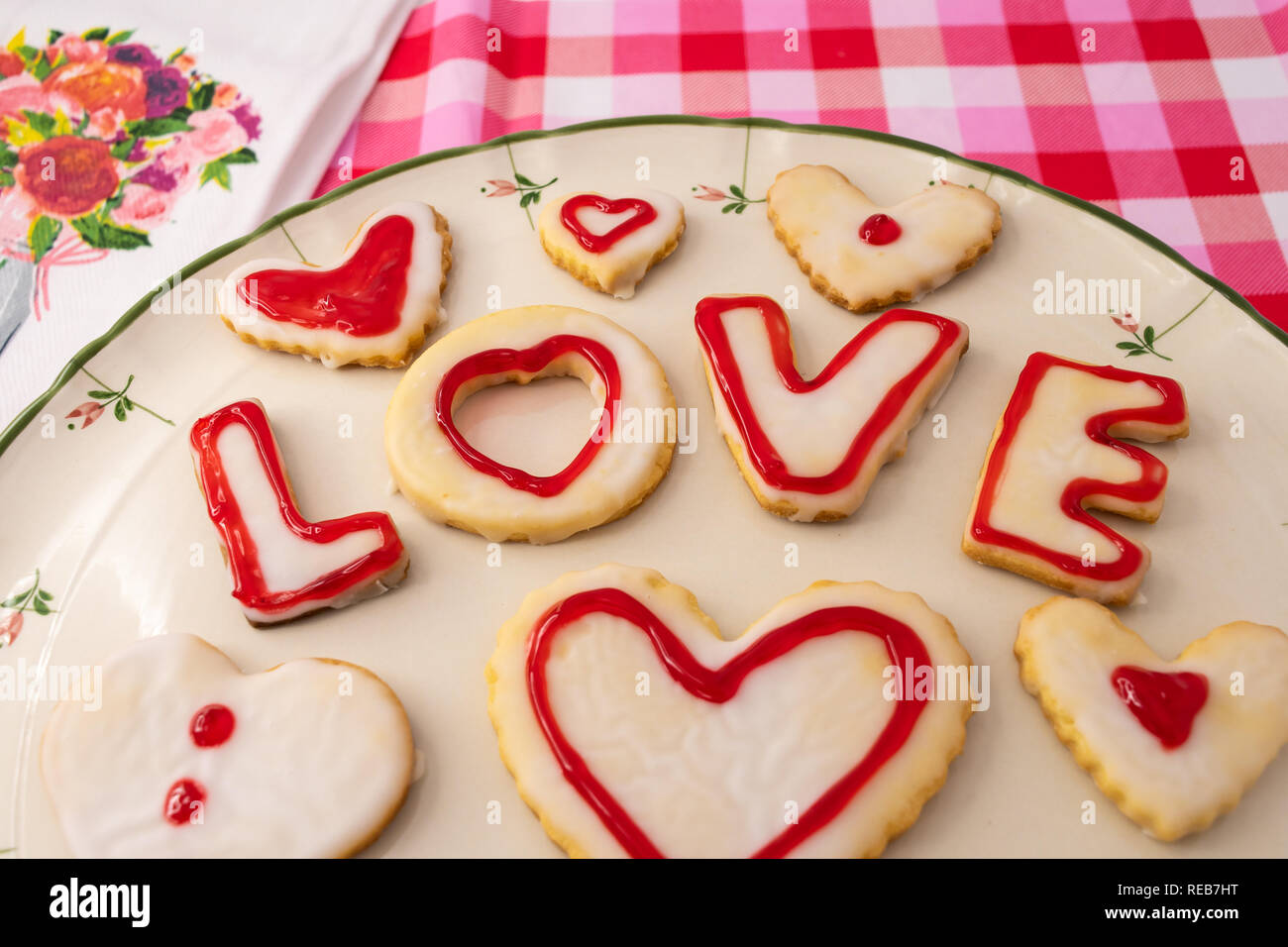 Valentine's Day cookies made in heart shapes frosted in white with red ...