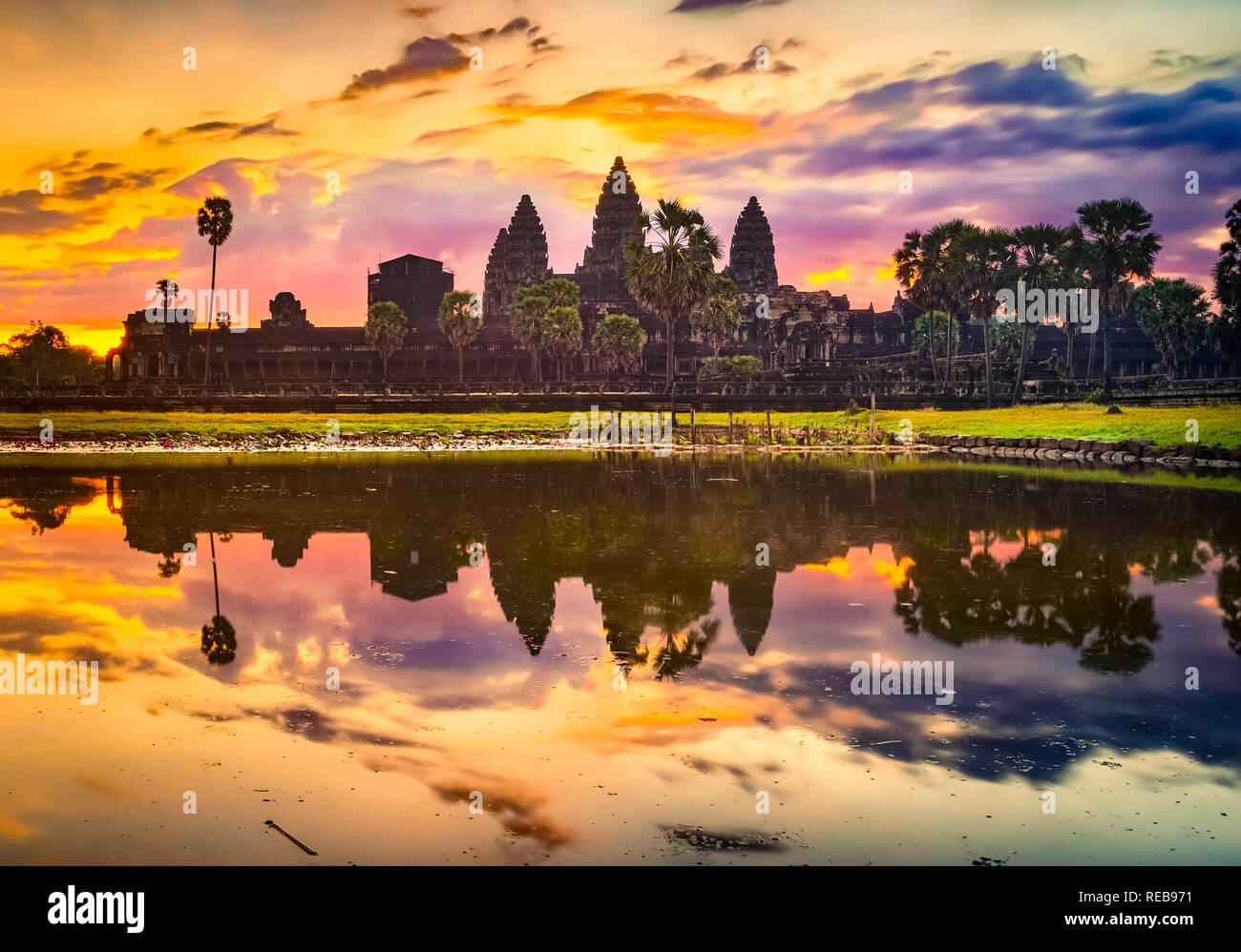 Angkor Wat temple reflecting in water of Lotus pond at sunrise. Siem ...