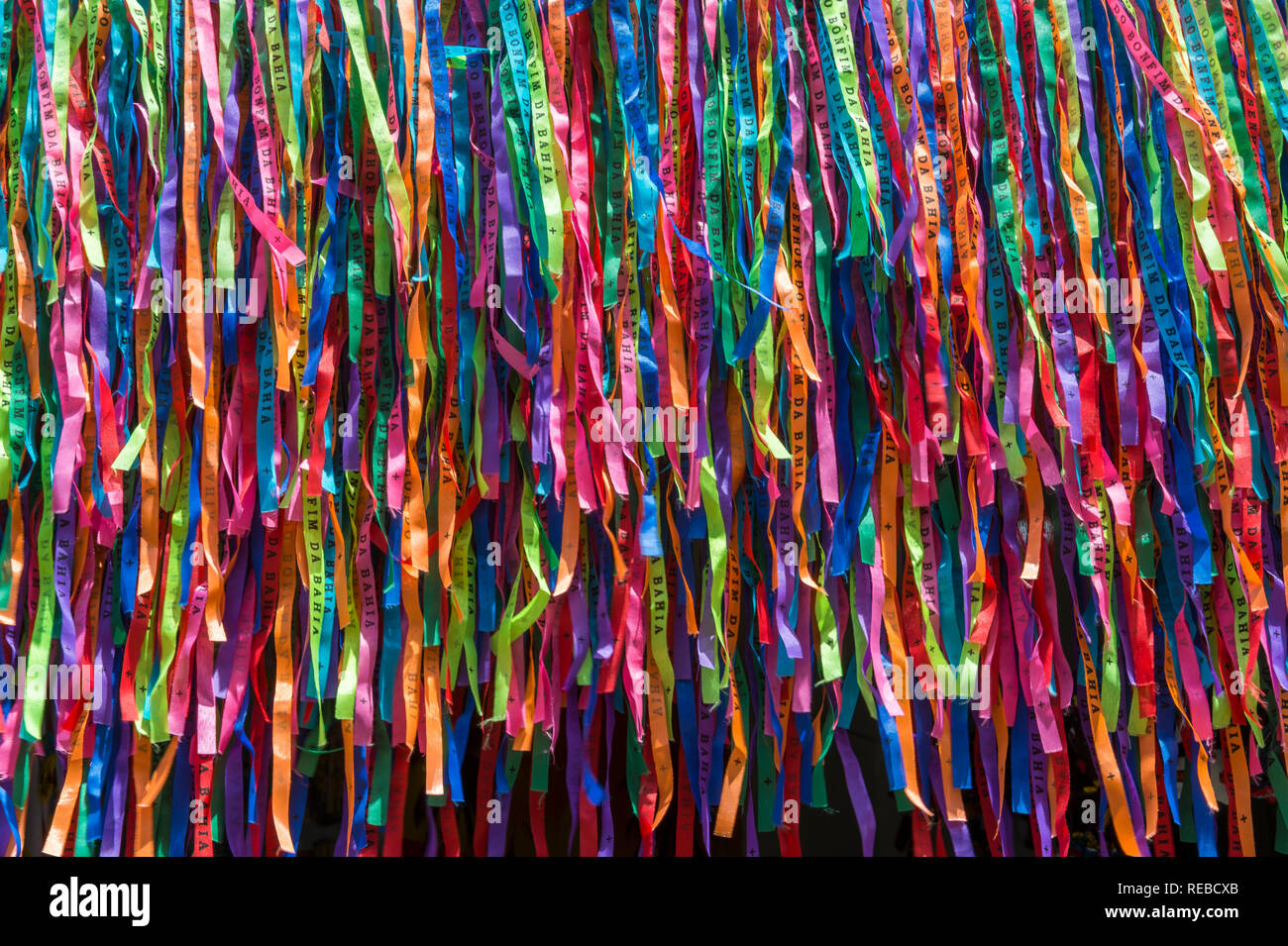 Bright sunny full frame background of a wall of colorful Brazilian wish ...