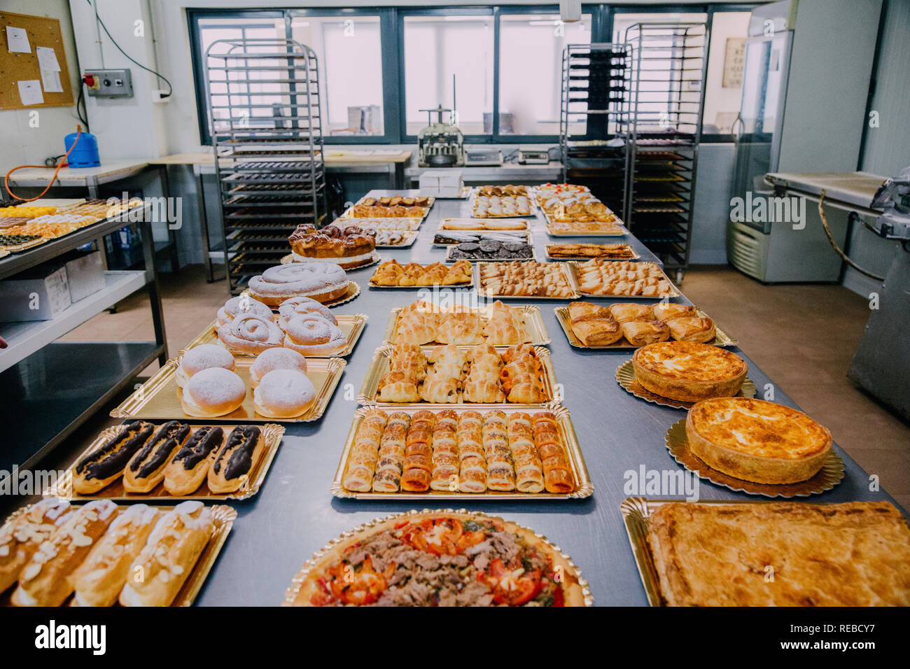 many different dishes prepared on the metal table of a food factory ...