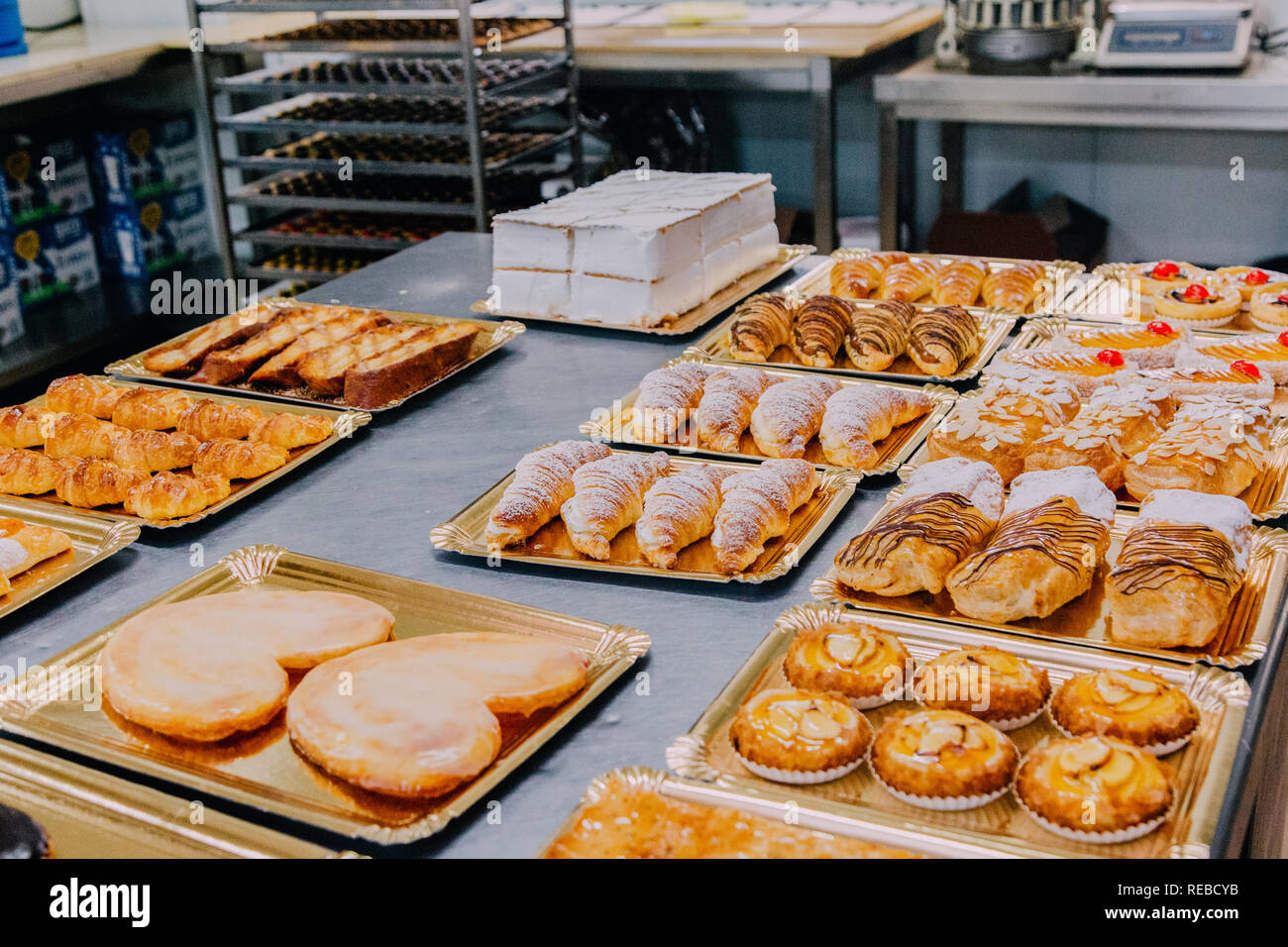 many different dishes prepared on the metal table of a food factory ...