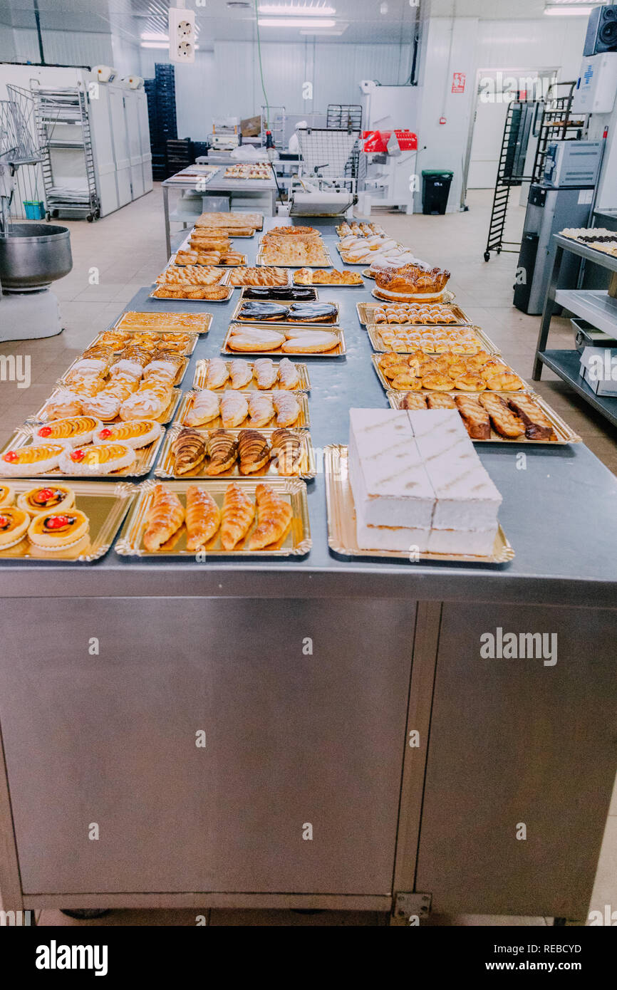 many different dishes prepared on the metal table of a food factory ...