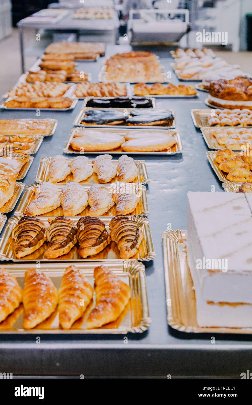 many different dishes prepared on the metal table of a food factory ...