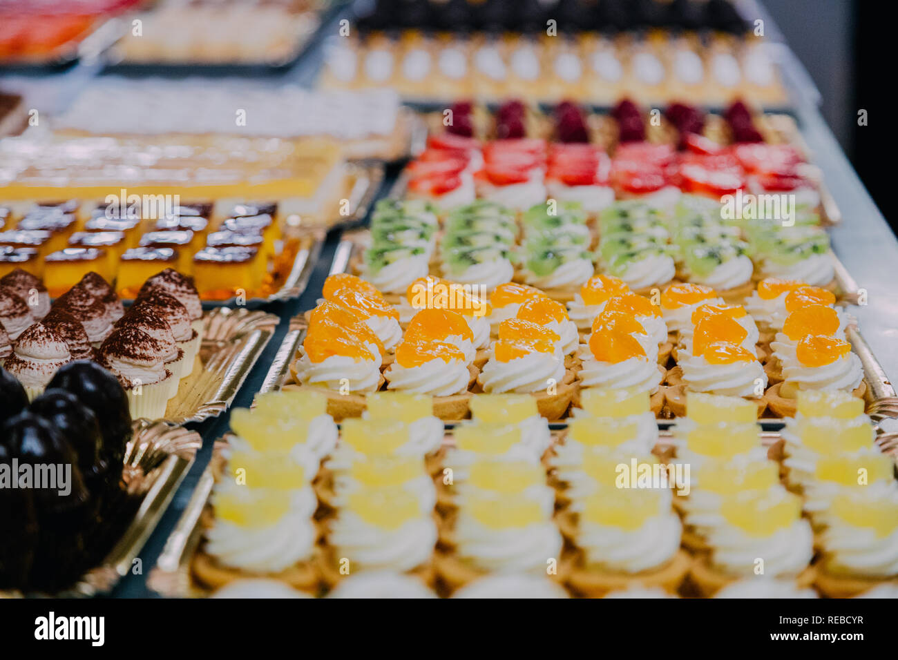 many sweets dishes prepared on the metal table of a food factory Stock ...