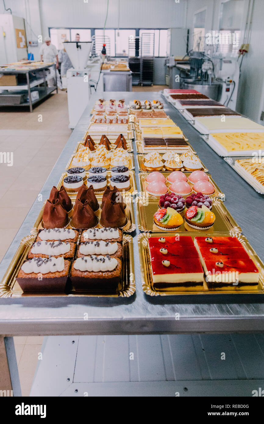 EDITORIAL many different sweets prepared on the metal table of a food ...