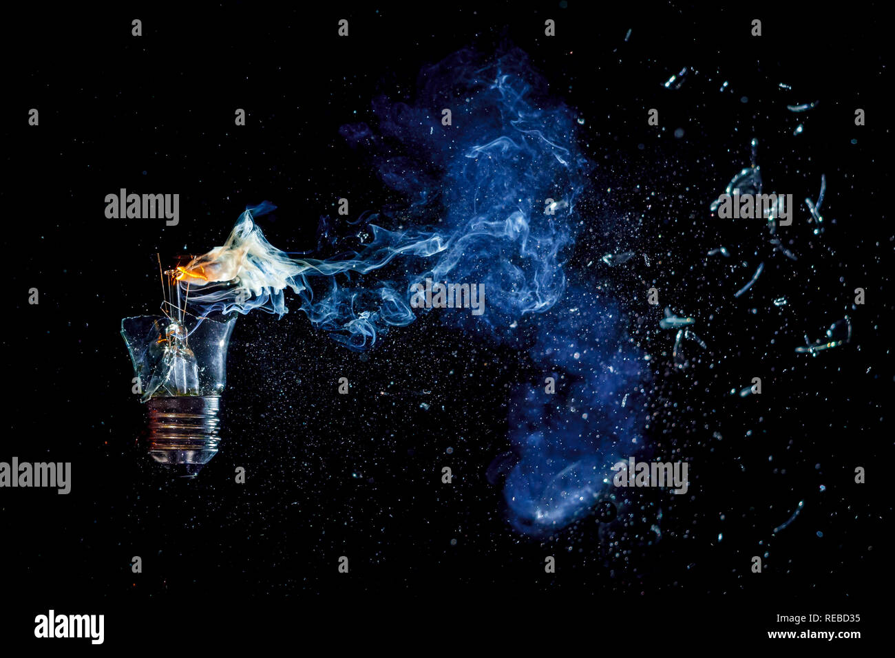 cosmic explosion of a burning light bulb with flying splinters and ...
