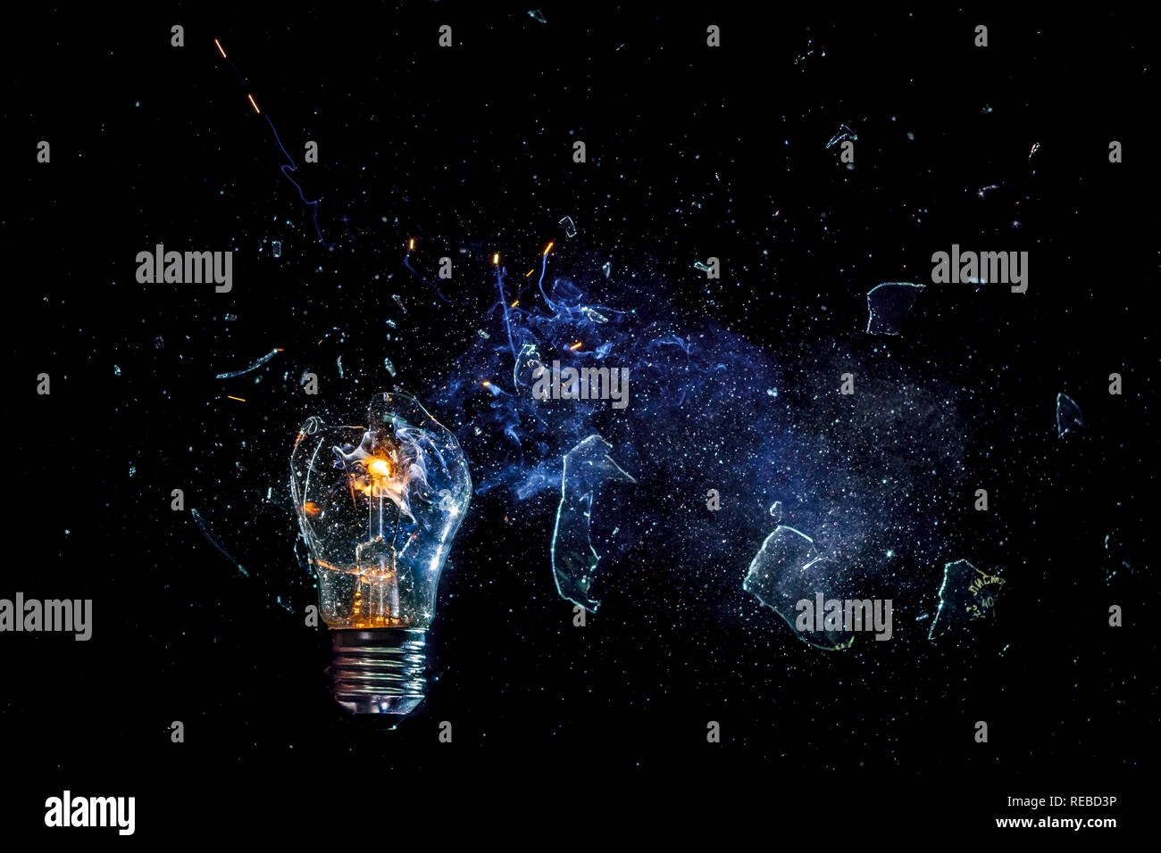 cosmic explosion of a burning light bulb with flying splinters and ...