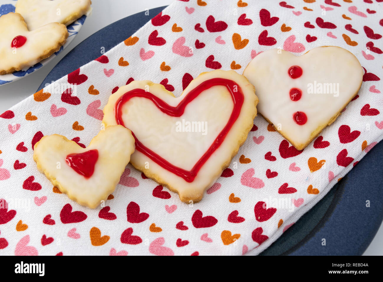 Valentine's Day cookies made in heart shapes frosted in white with red ...