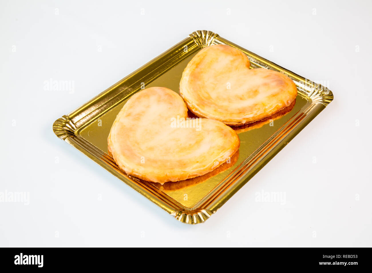 sweet pastries in a gold tray on white background Stock Photo - Alamy