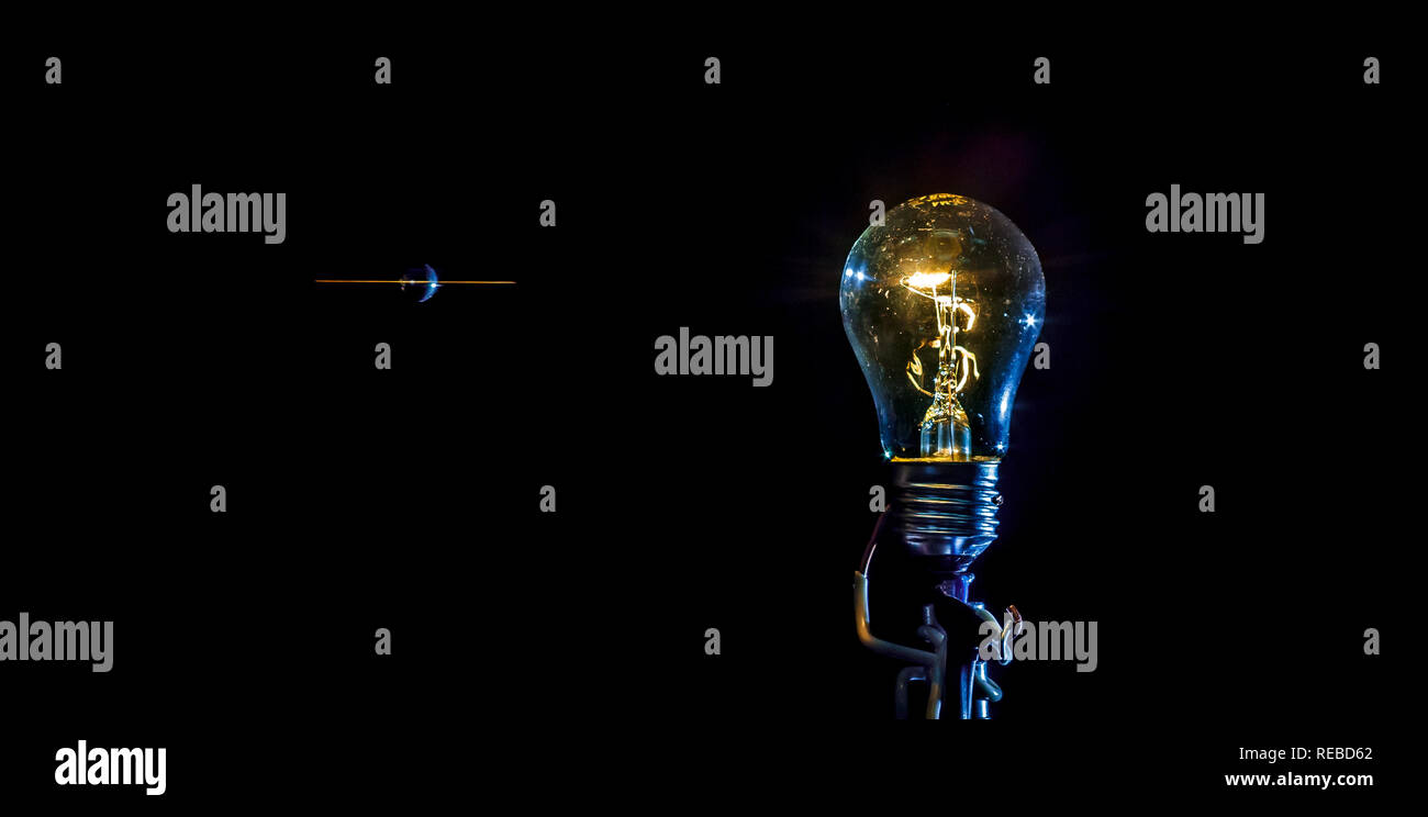 cosmic explosion of a burning light bulb with flying splinters and ...