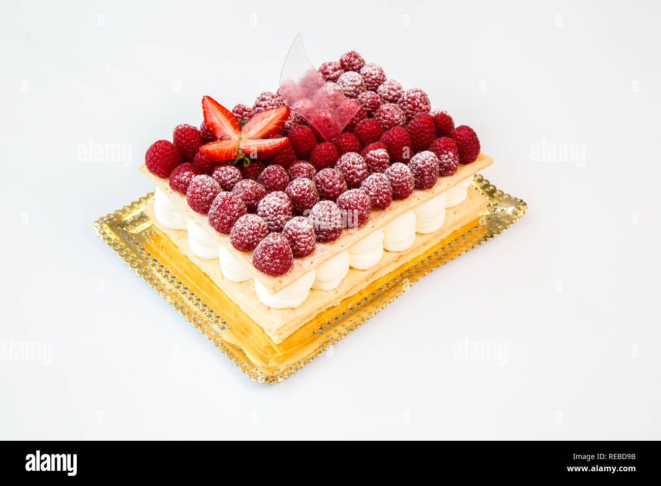 beautiful raspberry fruit cake on a gold tray on white background Stock ...
