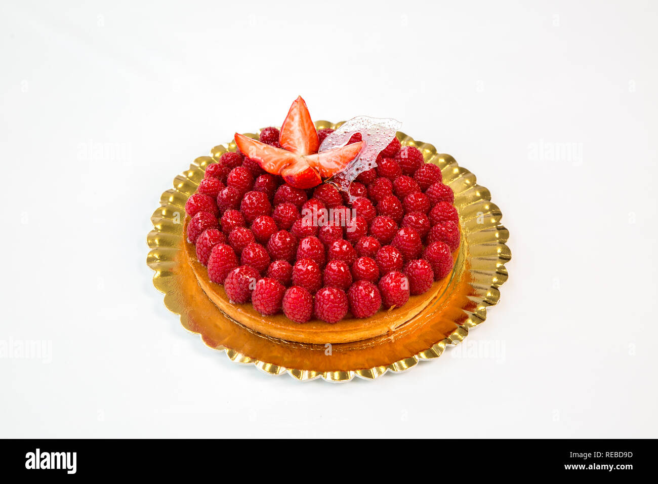 beautiful raspberry fruit cake on a gold tray on white background Stock ...