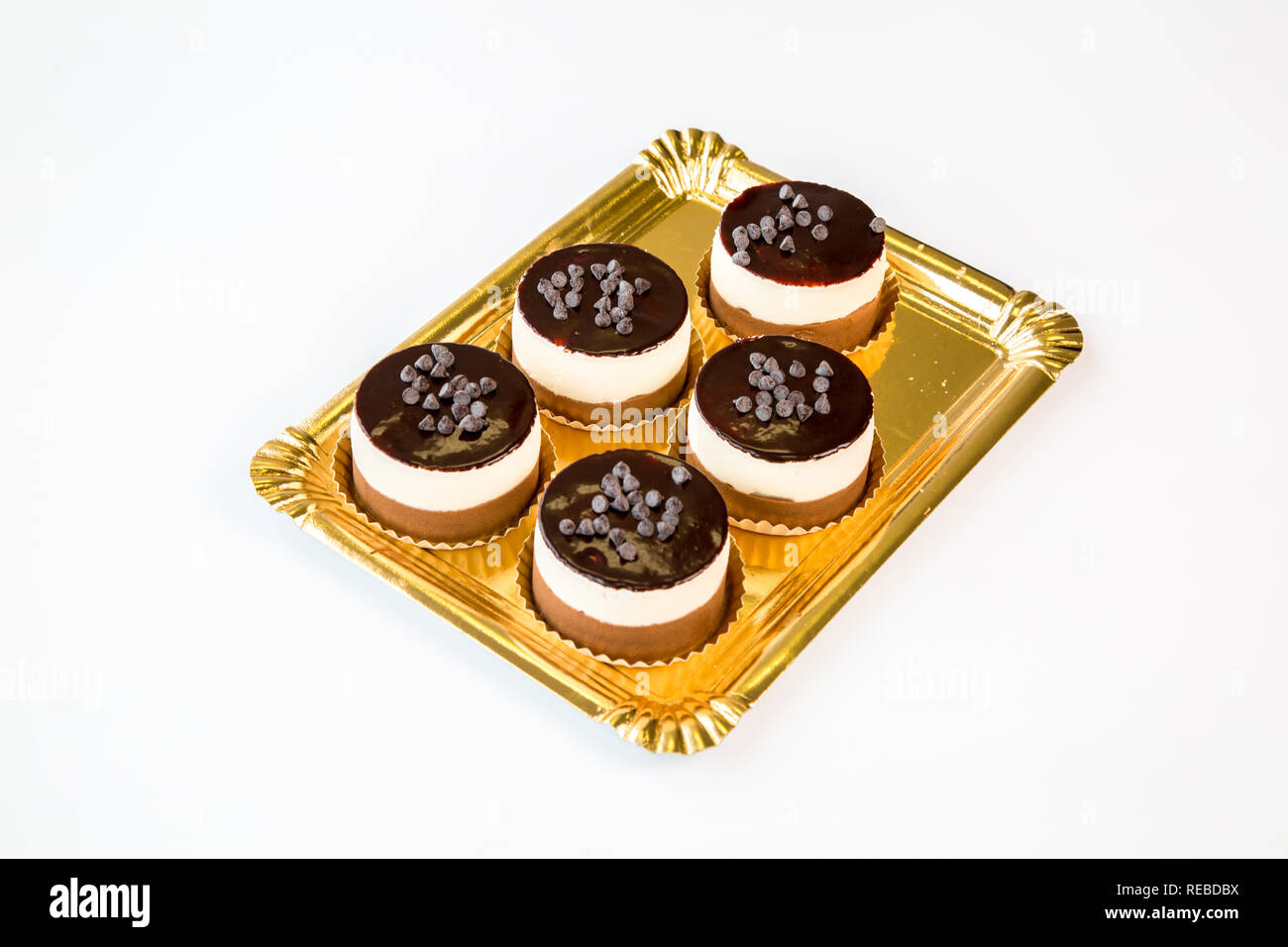 small chocolate cakes on a white background Stock Photo - Alamy
