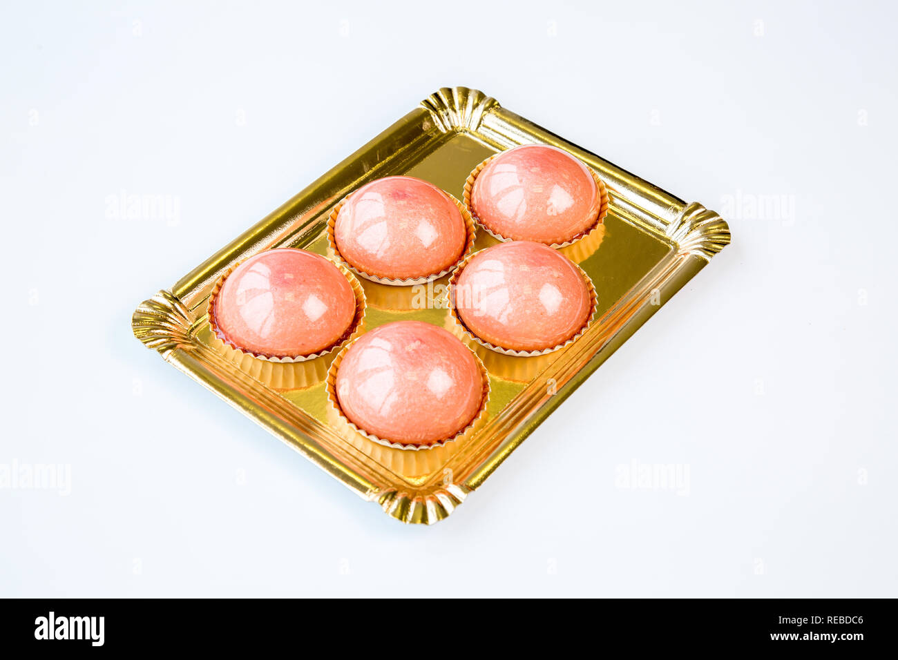small pink cake on a white background Stock Photo - Alamy