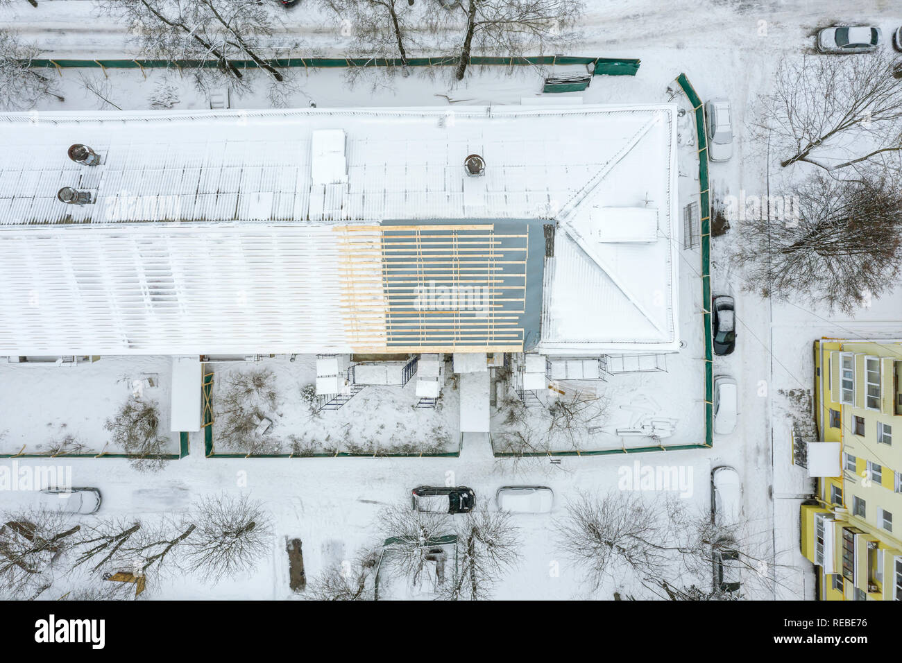 aerial top view of building roof under renovation in winter ...