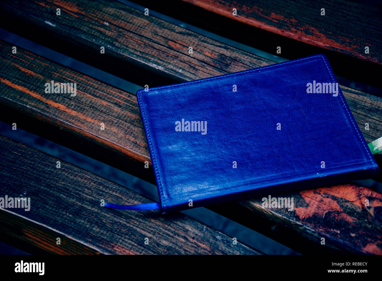 Notebook on bench in park, business concept Stock Photo - Alamy