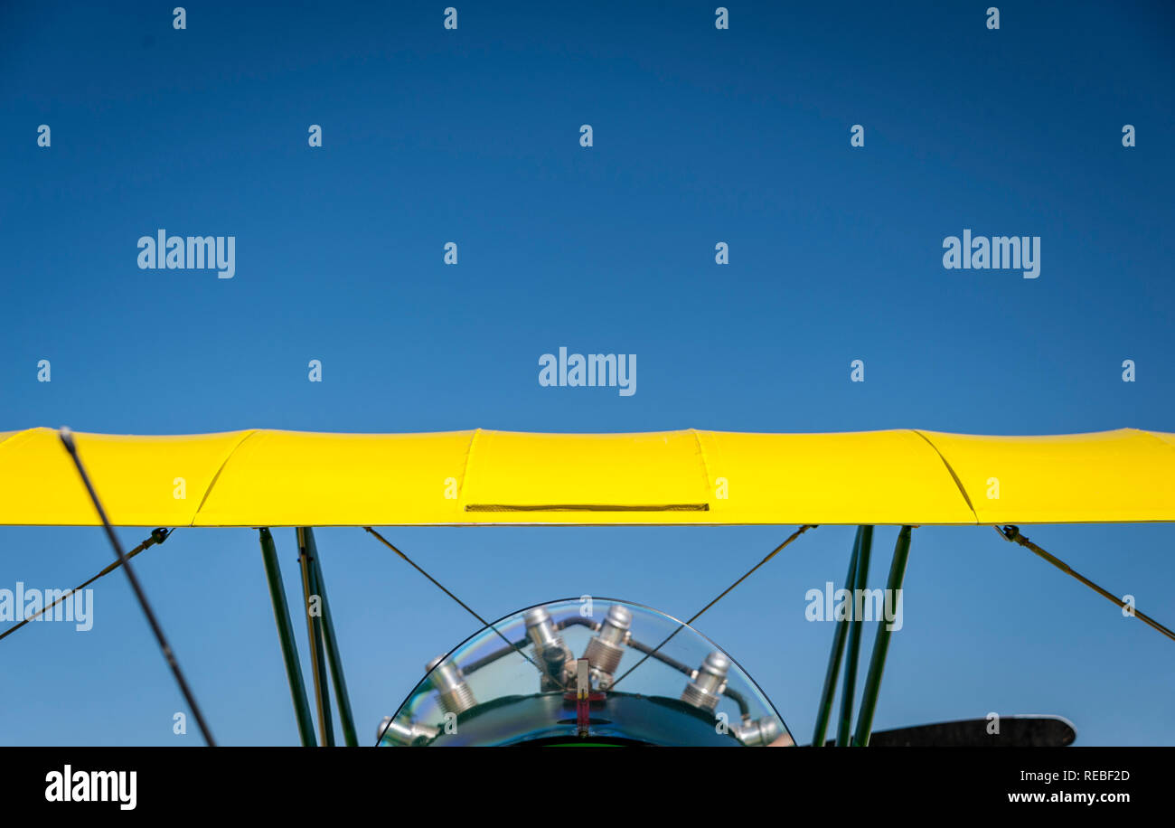 Vivid yellow top wing of a vintage biplane against a blue sky Stock ...