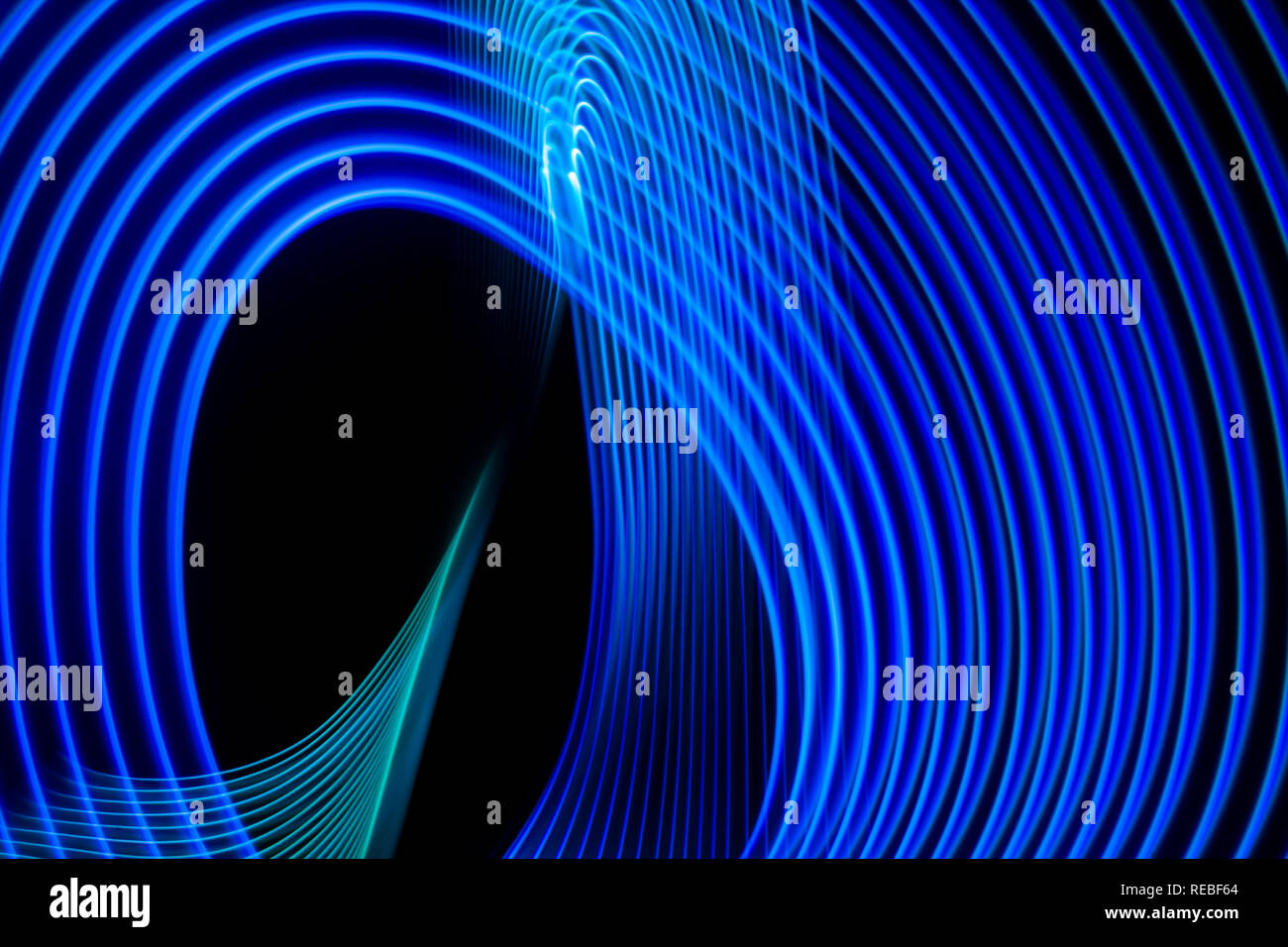 Abstract rainbow neon glowing crossing lines pattern. Dark background of colorful neon blue ...