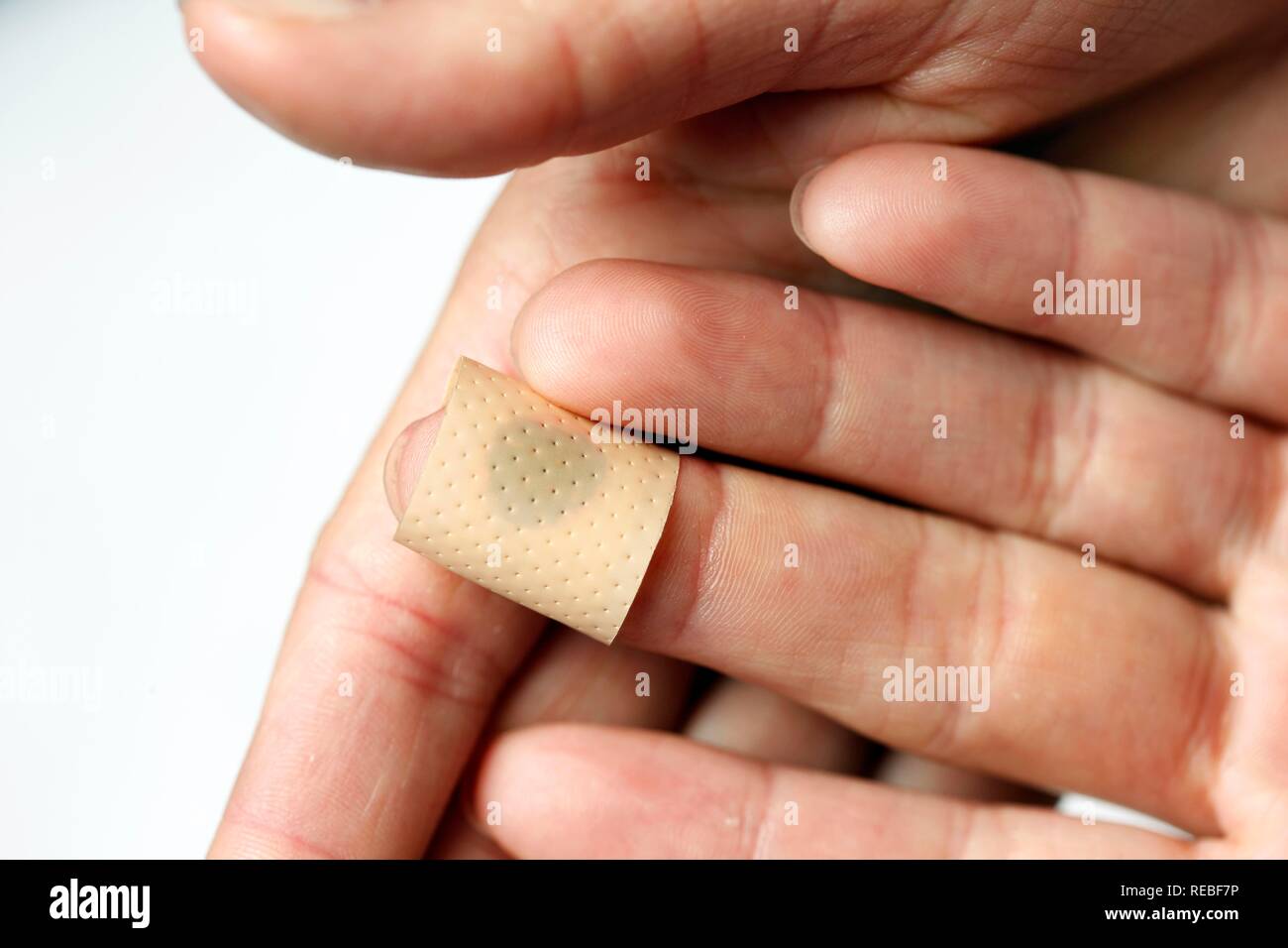 Adhesive bandage, applied to a little wound on a finger Stock Photo - Alamy