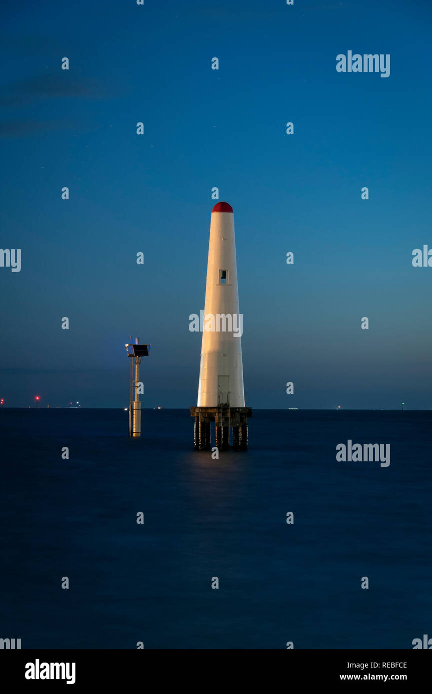 A white light beacon tower in the evening light, Port Phillip Bay ...
