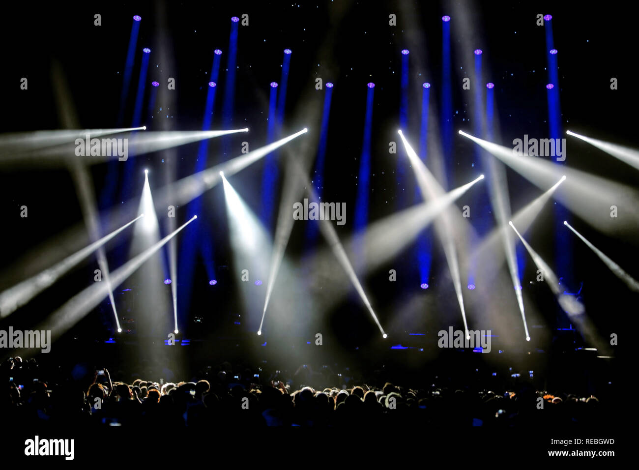 Lights and SpotLights on the stage during live concert with many people ...