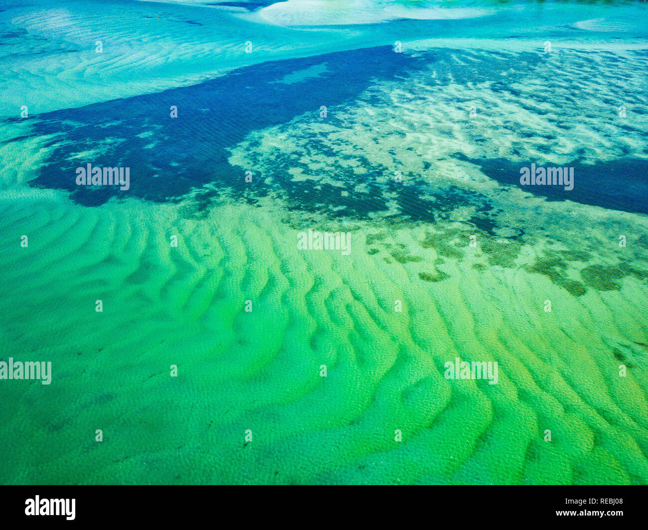 Incredible patterns and textures left by the sand with turquoise water ...