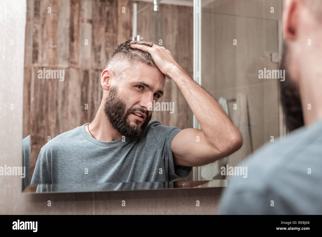 Cheerful bearded man fixing hi-res stock photography and images - Alamy