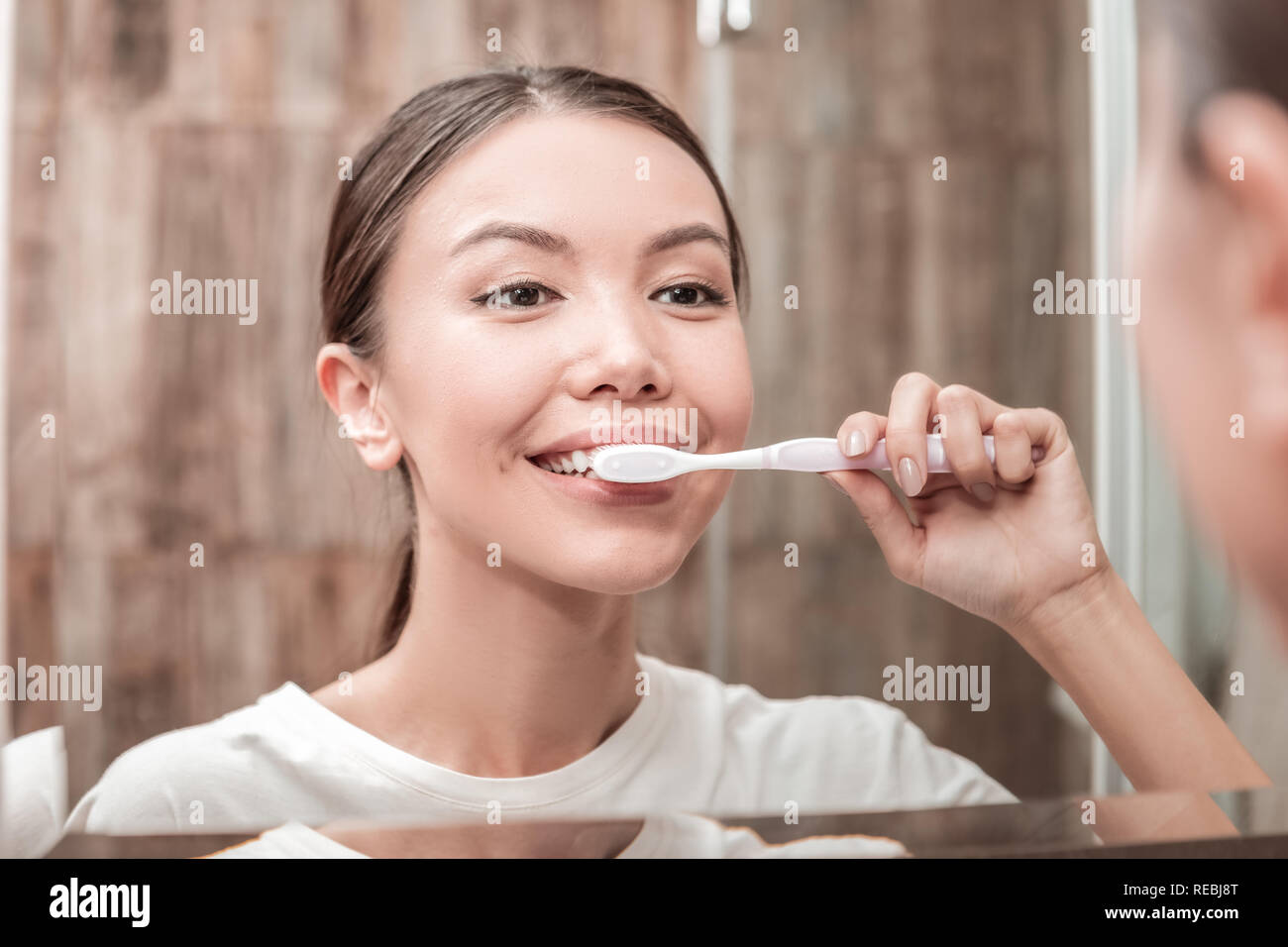 Close up of beautiful dark-eyed woman brushing teeth Stock Photo - Alamy